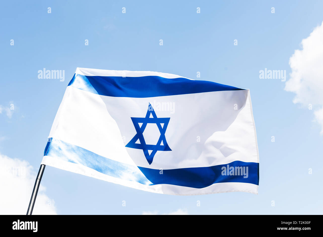 low angle view of national israel flag with blue star of david against ...