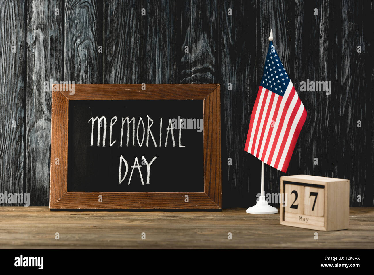chalkboard with memorial day lettering near american flag and wooden ... chalkboard with memorial day lettering near american flag and wooden ...