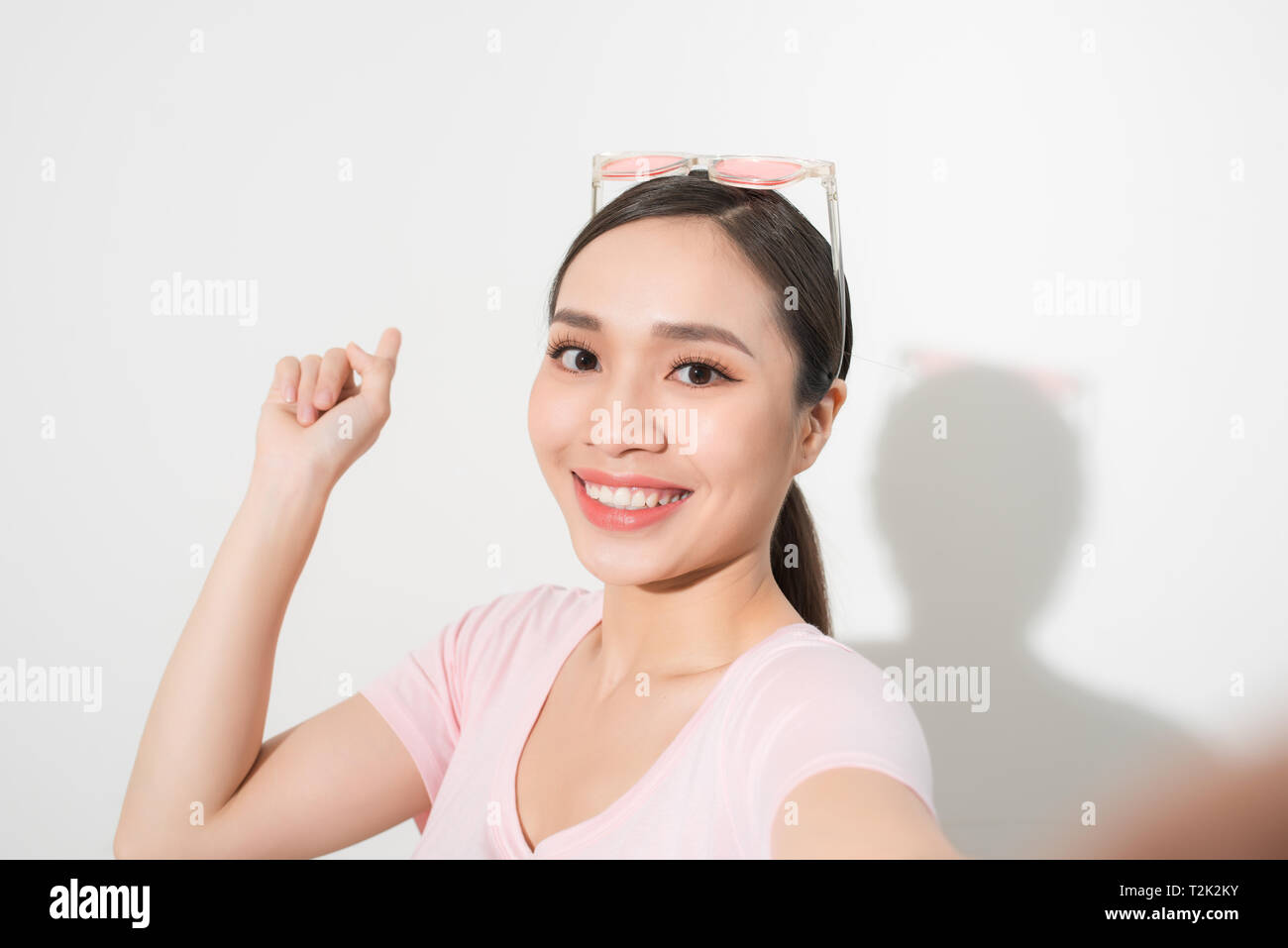 Young happy smile girl take selfie on white background Stock Photo - Alamy