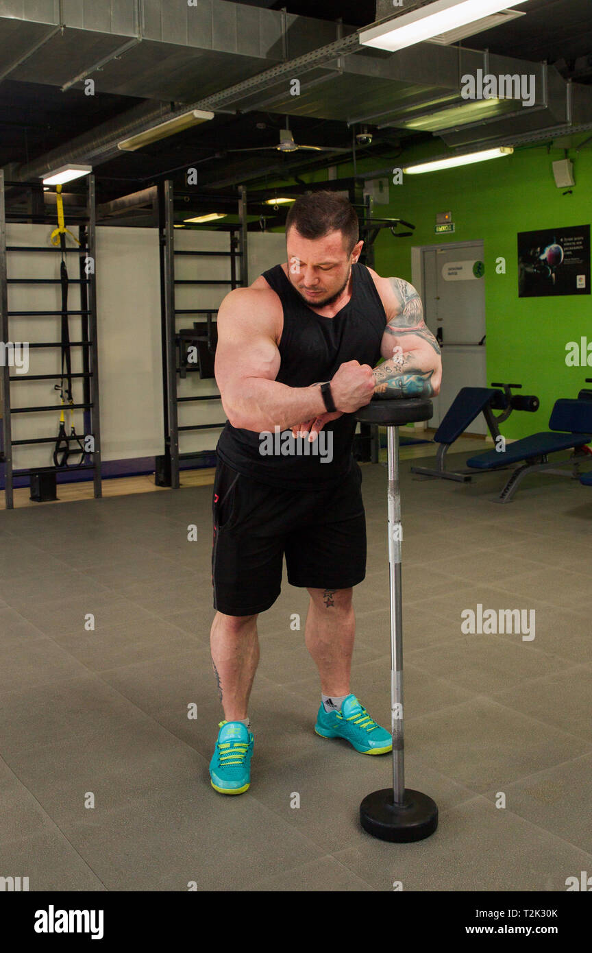 Strong european man , bodybuilder, standing in pose, demonstrate huge ...