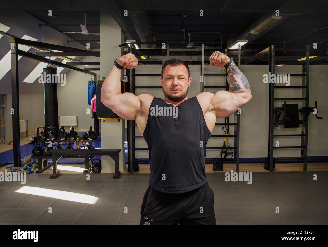Strong european man , bodybuilder, standing in pose, demonstrate with ...