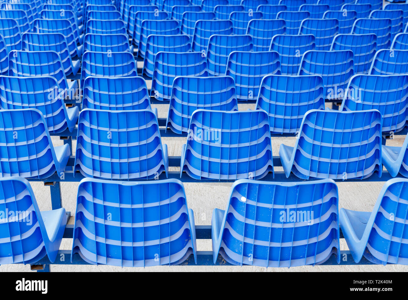 Rows of blue plastic chairs on a metal base. Back view Stock Photo - Alamy