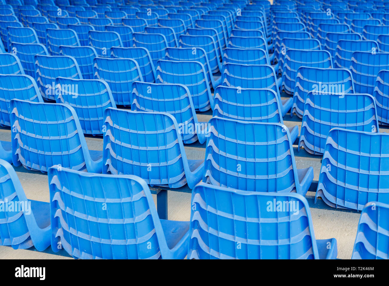 Rows of blue plastic chairs on a metal base. Back view Stock Photo - Alamy