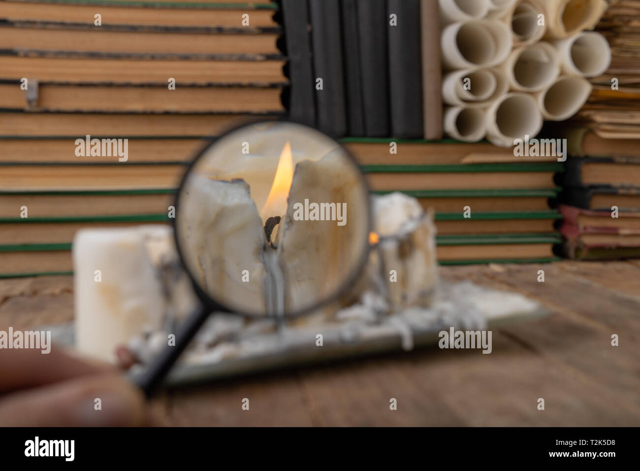 An old candle seen through a magnifying glass. Candle fire seen in a ...