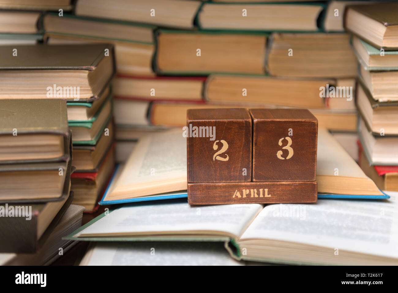 wooden calendar on the background of books, world book day Stock Photo ...