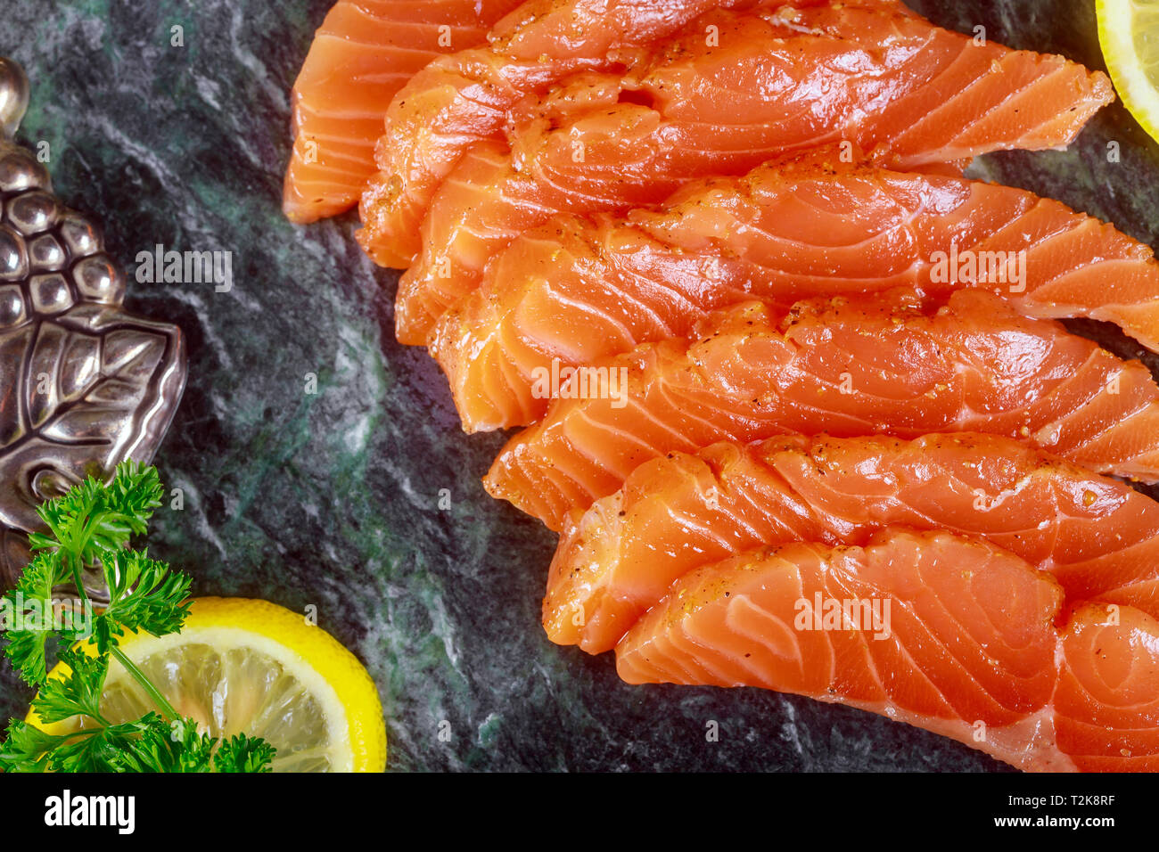 Raw salmon with lemon on marble plate background Stock Photo - Alamy