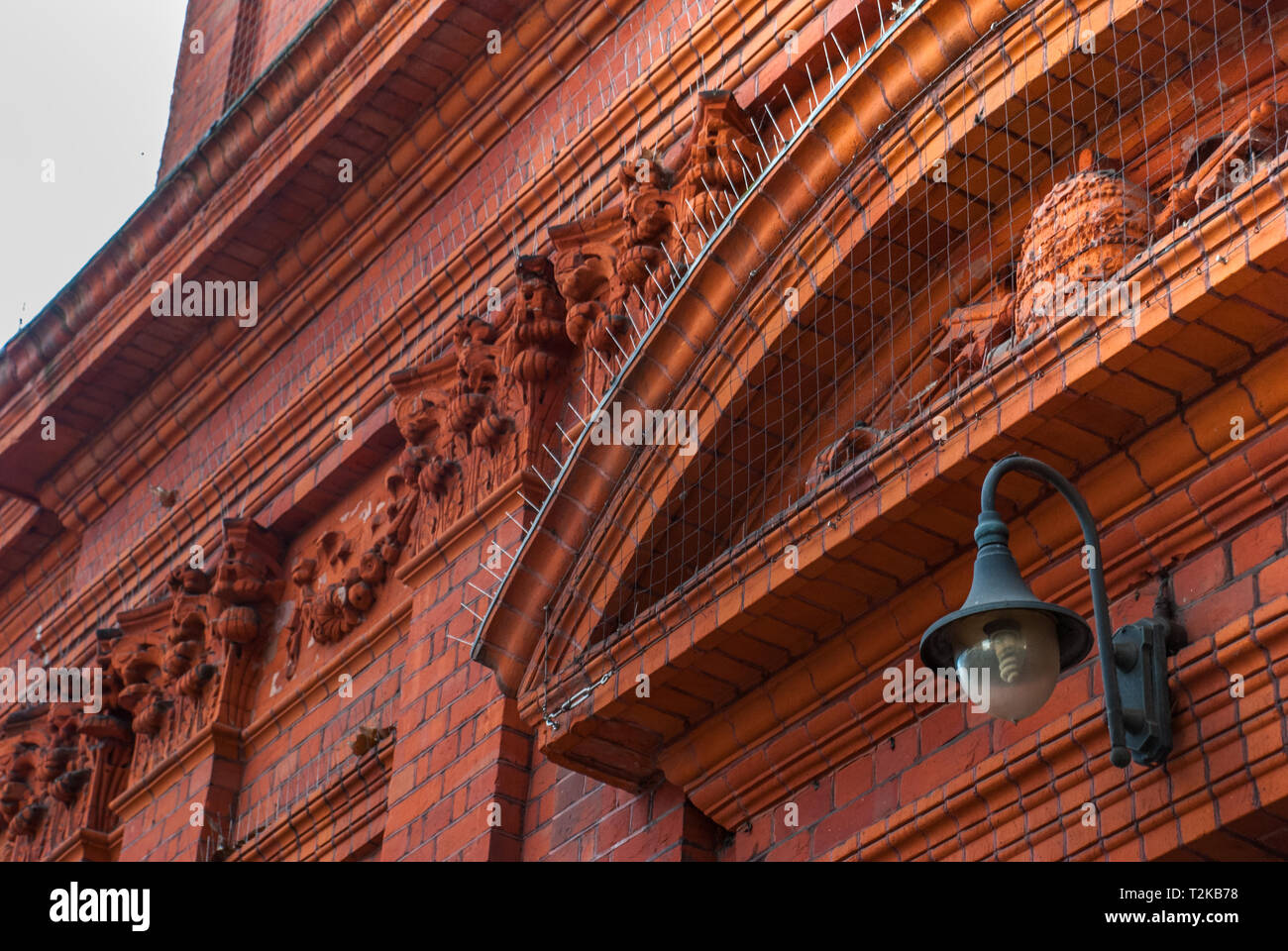 In front of a beautiful and distinctive red-orange stone building in ...