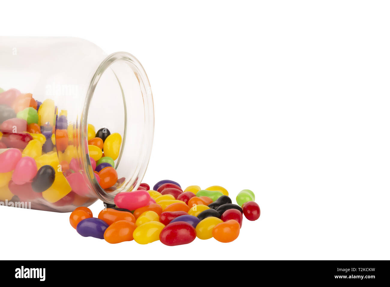 Small glass jar with colored jelly beans scattered isolated on white ...