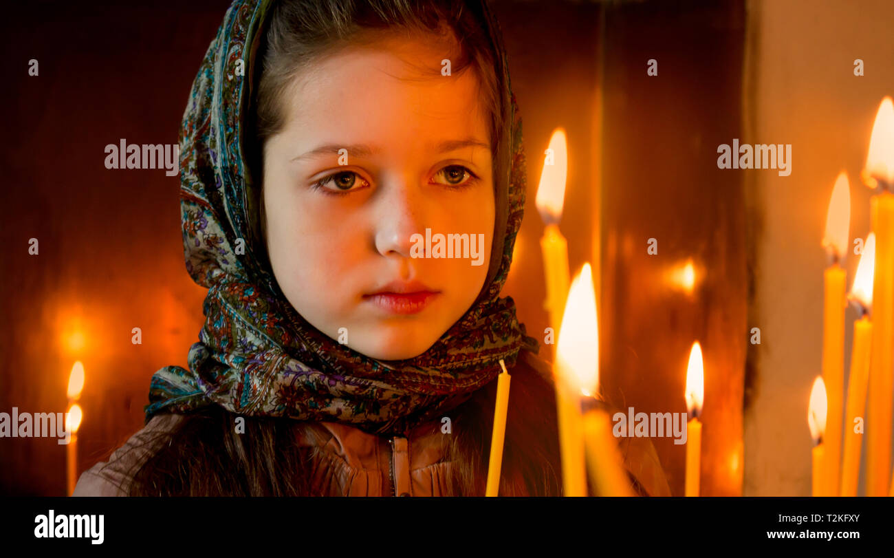 Child in the Orthodox Church near the candles Stock Photo - Alamy