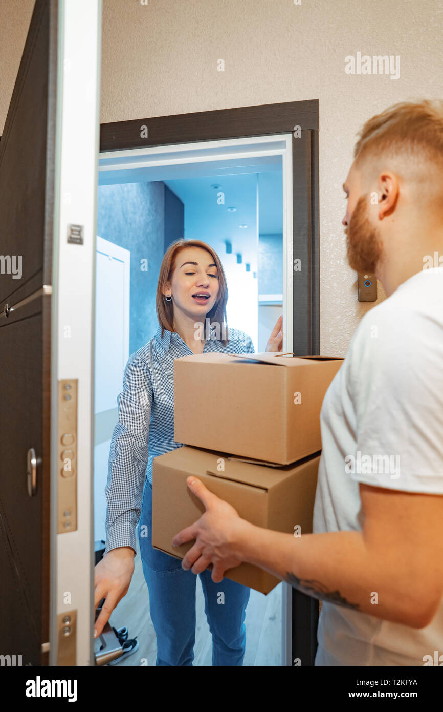Belivery man delivering parcel box to recipient - courier service ...