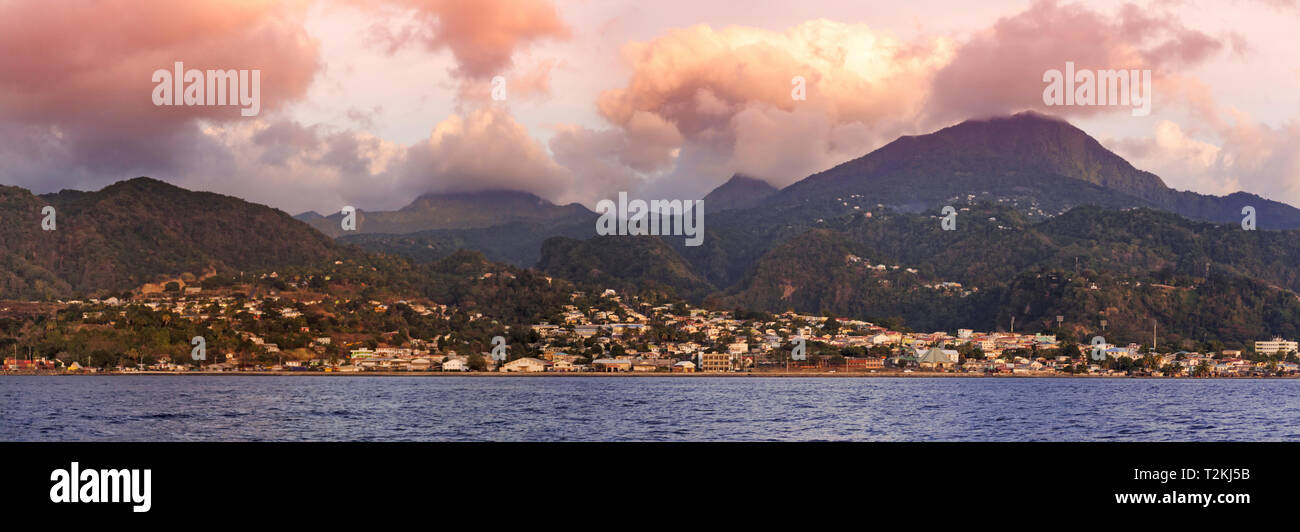 A panorama of Roseau at sunset from the sea . This is the tropical ...