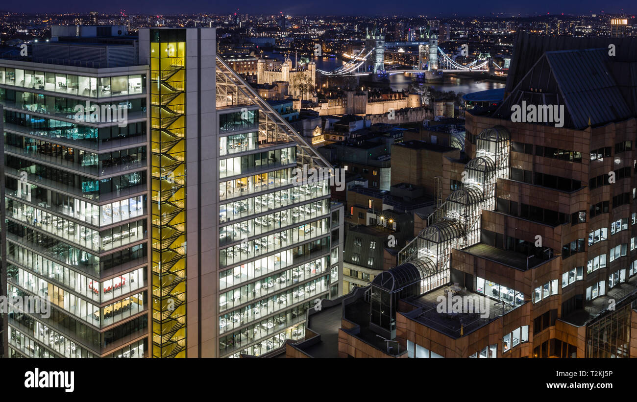 Tower Bridge and London are illuminated as night falls. The view from ...