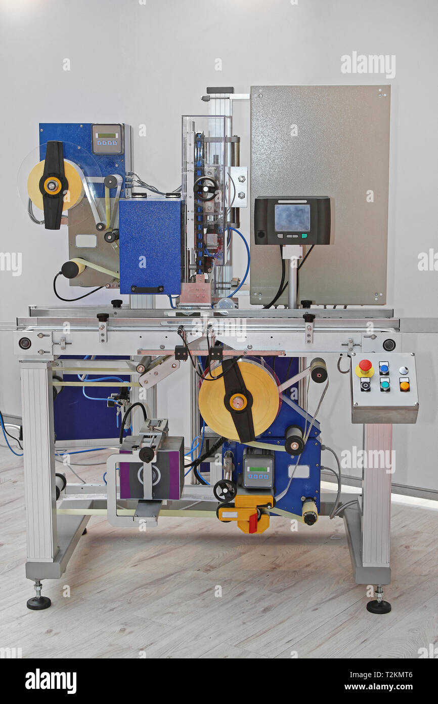 Automated Labeling Machine at Production Line in Factory Stock Photo ...