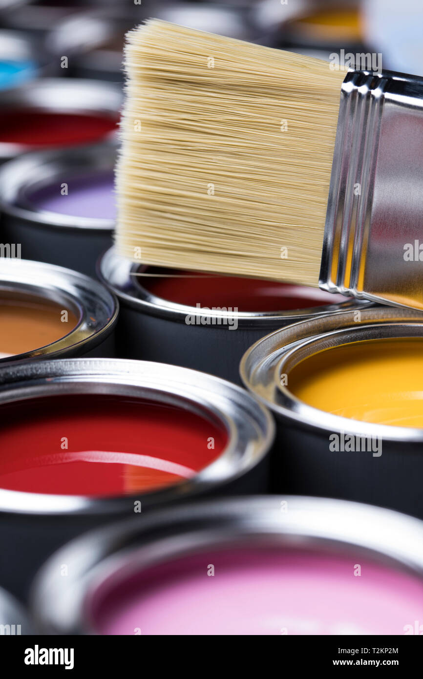 Tin cans with paint, brushes and bright palette of colors Stock Photo ...