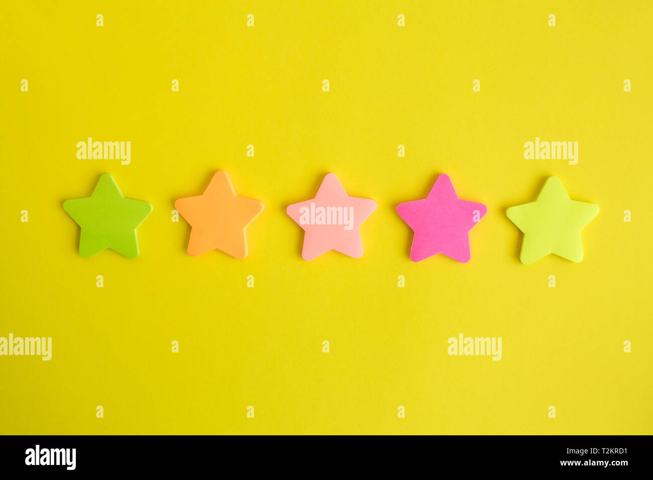 Five colorful stars on yellow background minimal rating creative ...