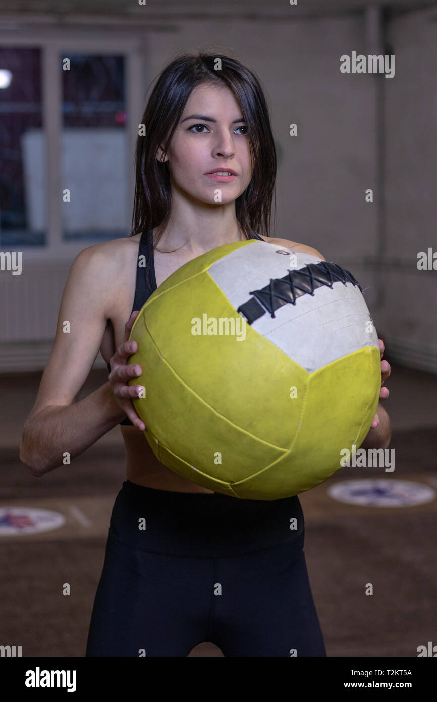 The girl is engaged with a crossfit ball in the gym Stock Photo - Alamy