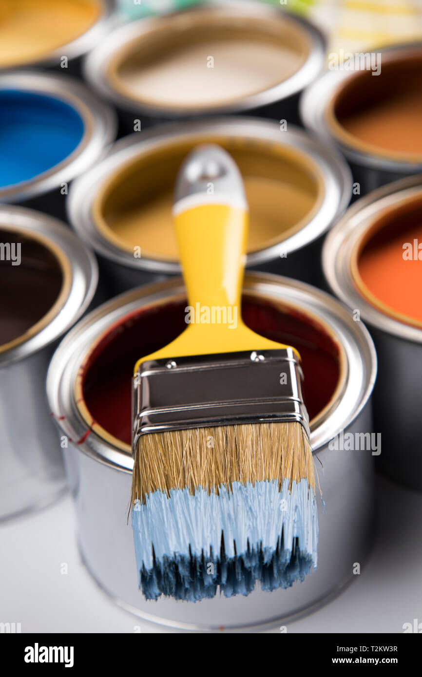 Metal tin cans with color paint and paintbrush Stock Photo - Alamy