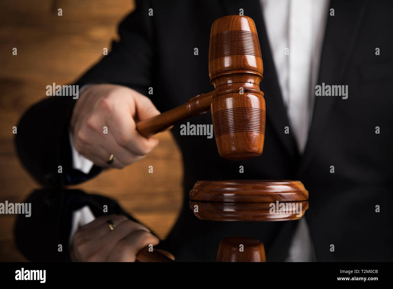 Justice and law concept, Male judge in a courtroom striking the gavel ...