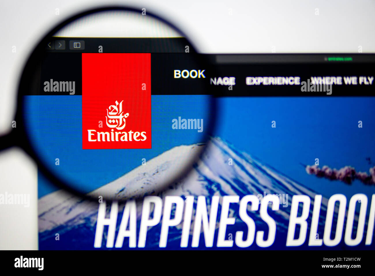 Air carrier Emirates website homepage. Emirates logo visible through a ...