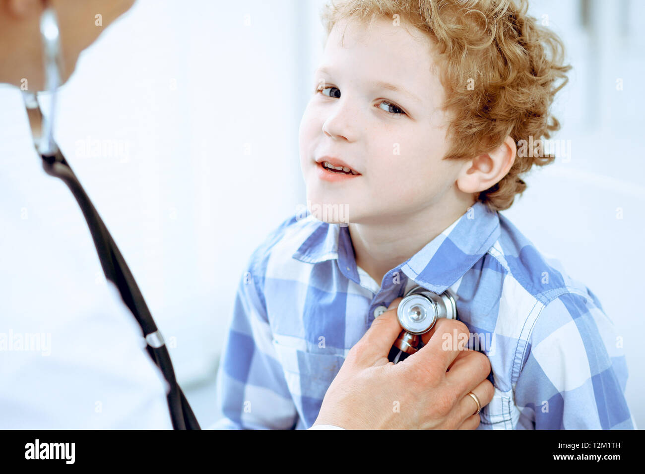 Doctor and patient child. Physician examining little boy. Regular ...