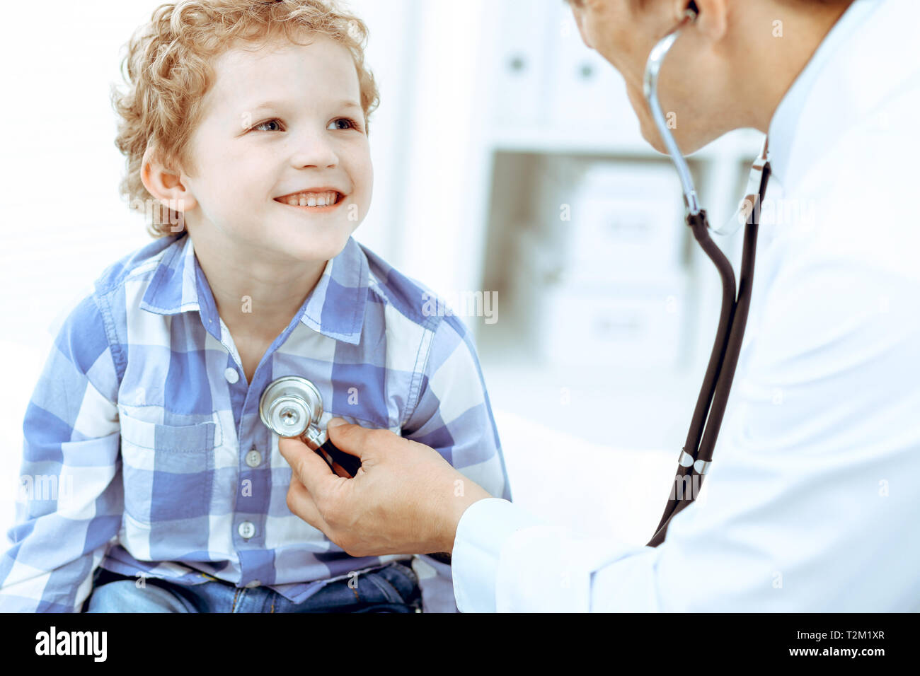Doctor and patient child. Physician examining little boy. Regular ...