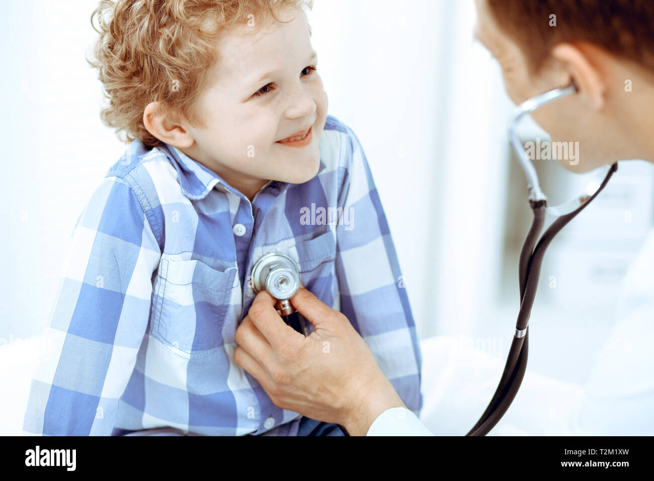 Doctor and patient child. Physician examining little boy. Regular ...