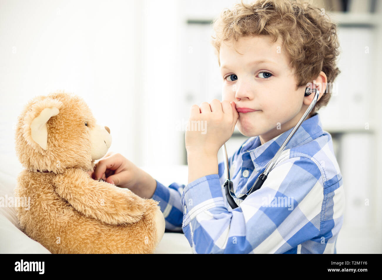 Doctor and patient child. Physician examining little boy. Regular ...