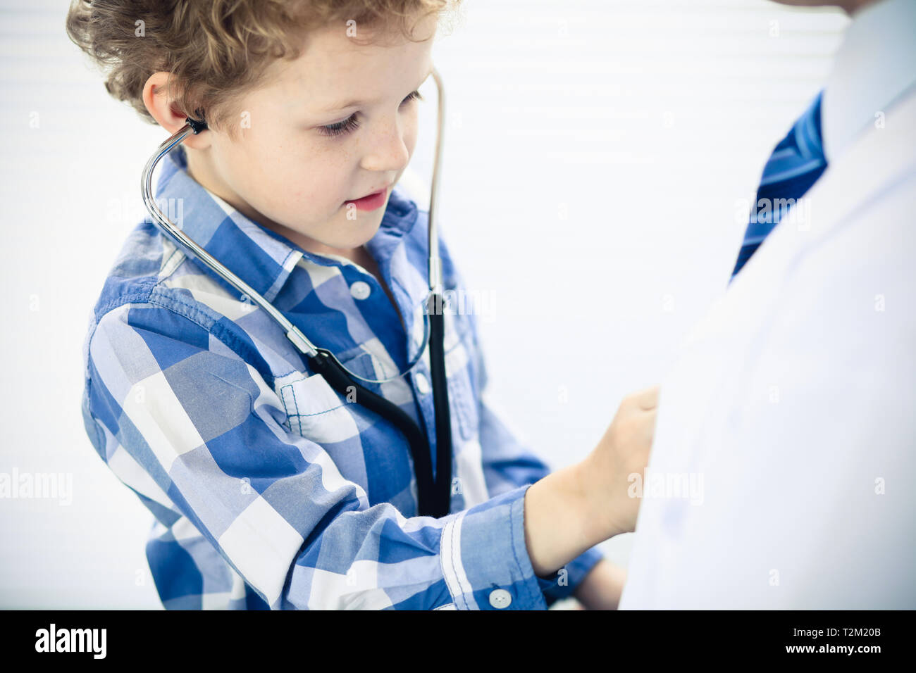 Doctor and patient child. Physician examining little boy. Regular ...