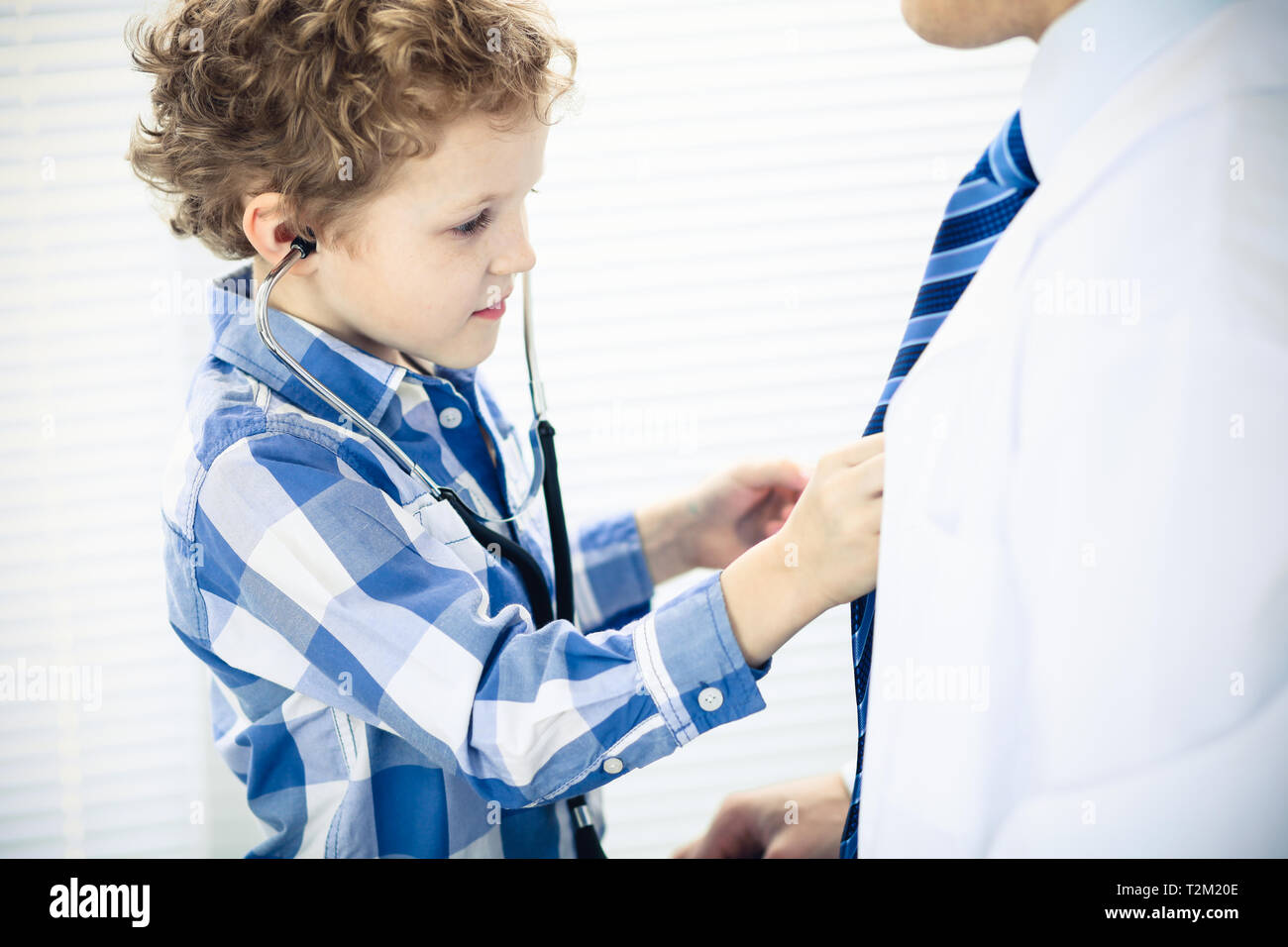 Doctor and patient child. Physician examining little boy. Regular ...