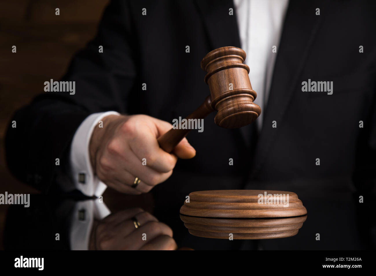 Justice and law concept, Male judge in a courtroom striking the gavel ...