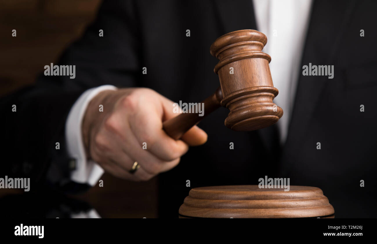 Justice and law concept, Male judge in a courtroom striking the gavel ...