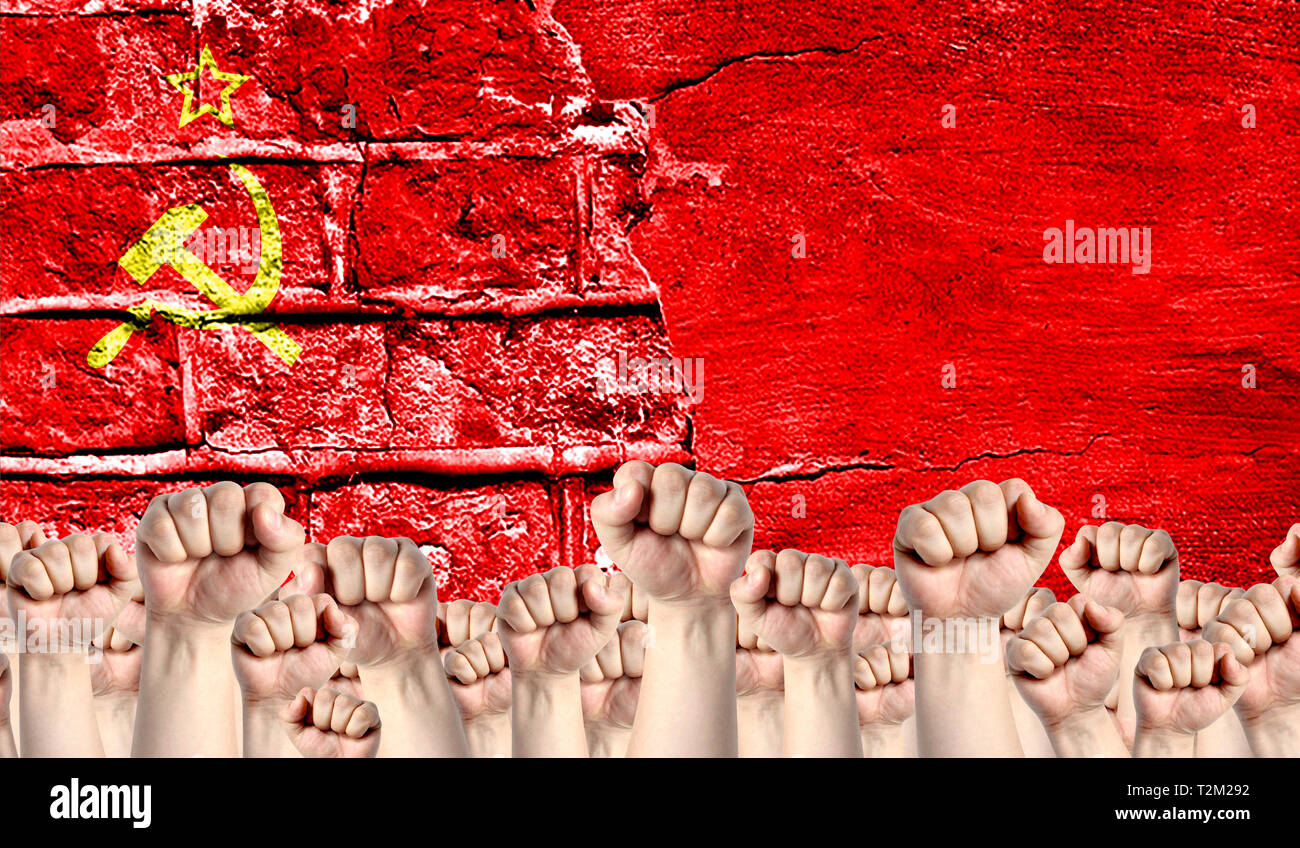 Male hands clenched in a fist raised up against the backdrop of a ...
