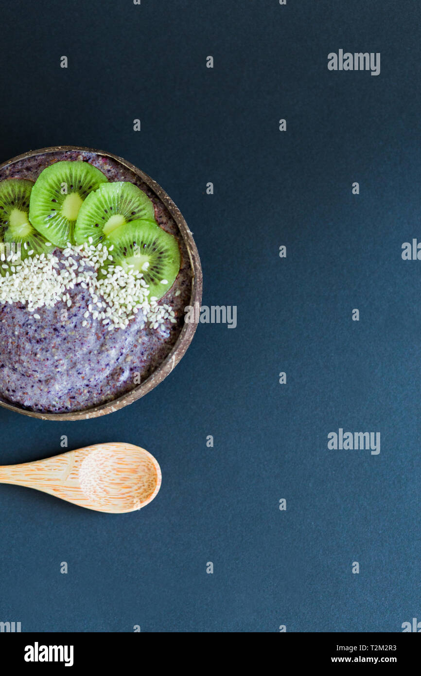 Healthy smoothie with fruits, plate made from coconut shell and wood ...