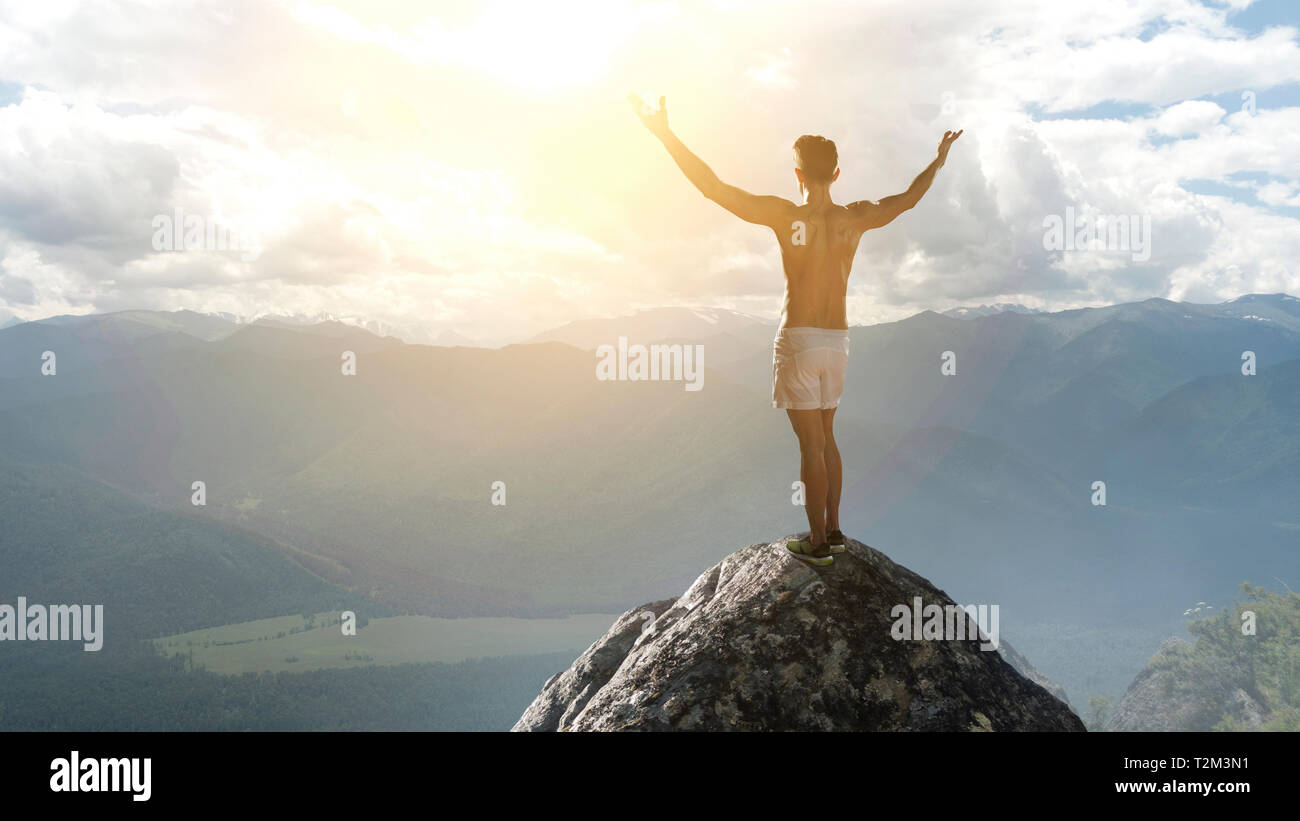 Young athlete outdoor on top of rock viewing sunrise. Mixed media Stock ...