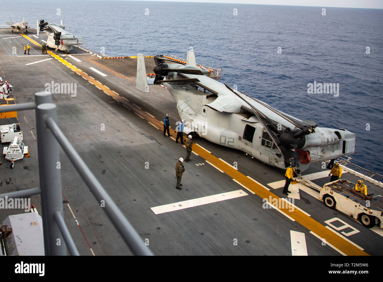 U.S. Marines and Sailors conduct flight operations aboard the ...