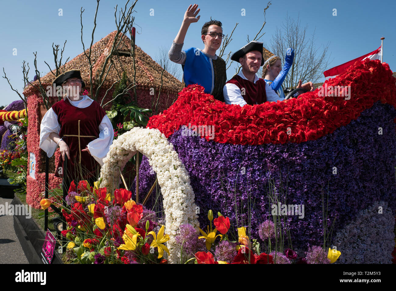 A parade of floats covered with flowers travels around the cities ...