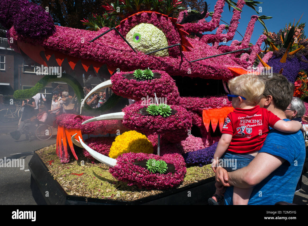 A parade of floats covered with flowers travels around the cities ...