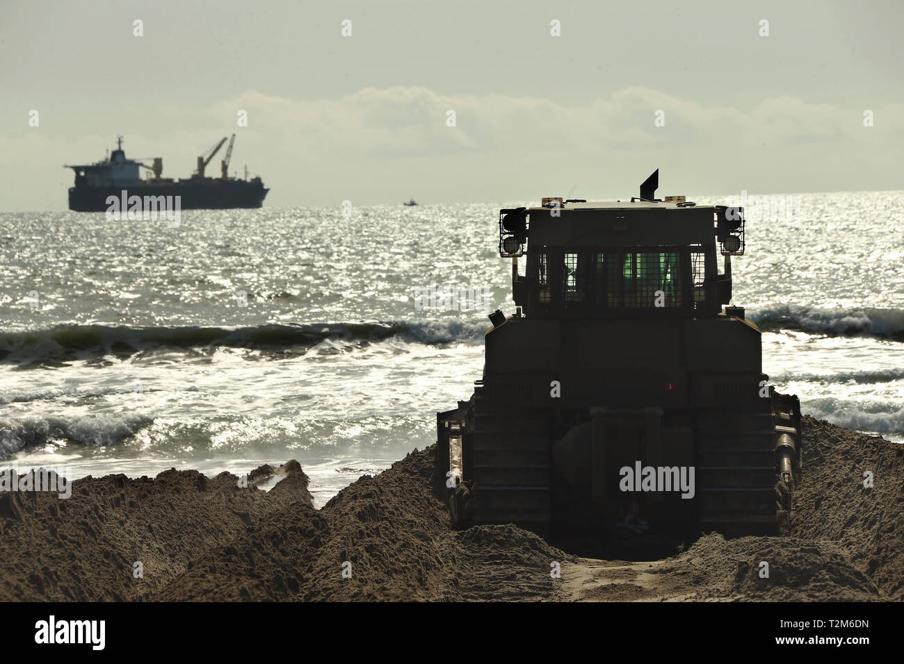 U.S. Navy Sailors prepare a beach for an offload of equipment and ...