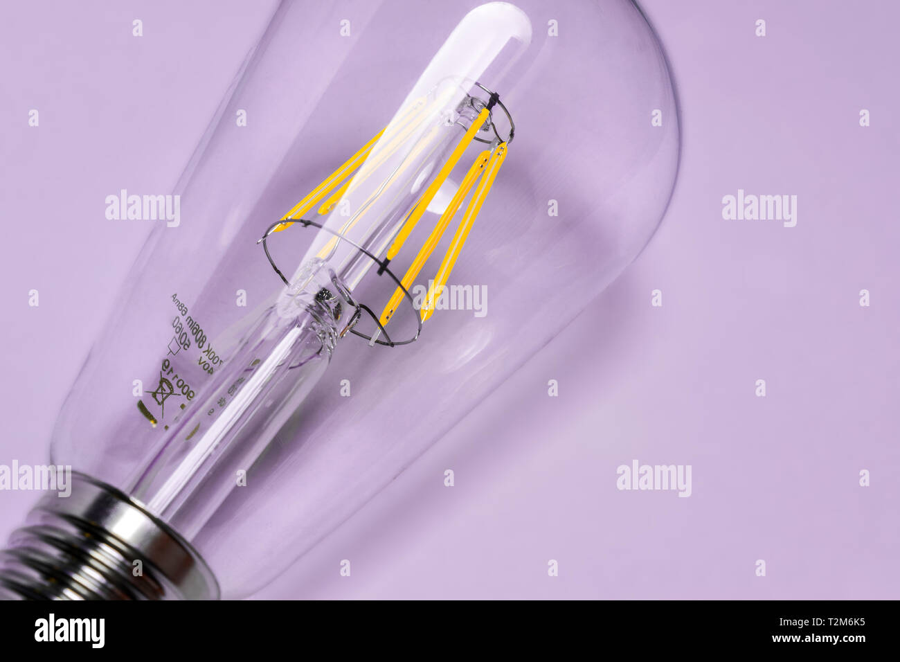 Close-up of a vintage-shaped electric led bulb with glass and cables on ...