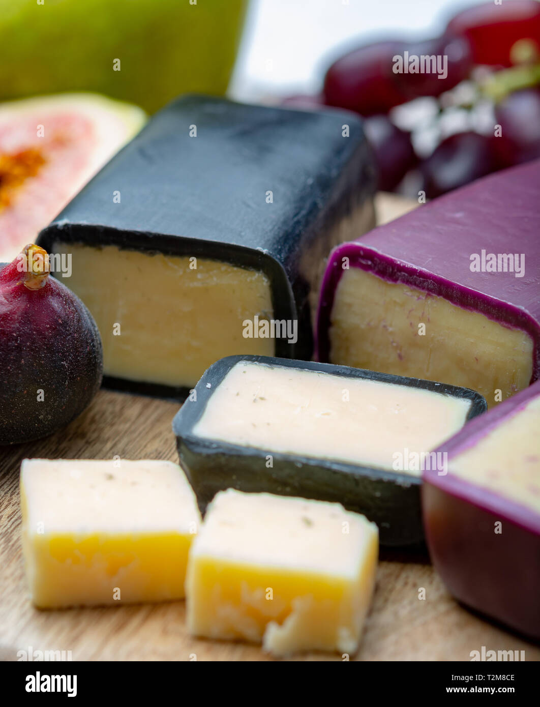 Mini black and dark red waxed cheddar cheeses made from West Country ...