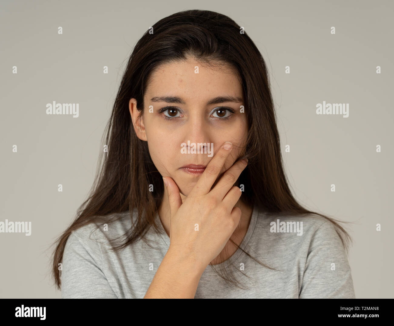 Close up of young sad woman, serious and concerned, looking worried and ...