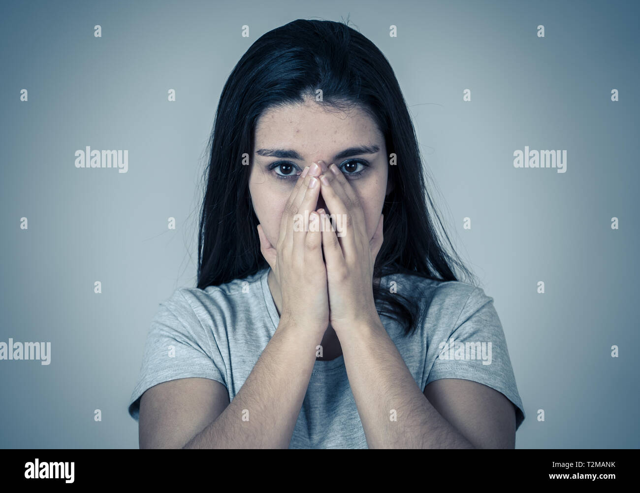 Close up of young sad woman, serious and concerned, looking worried and ...