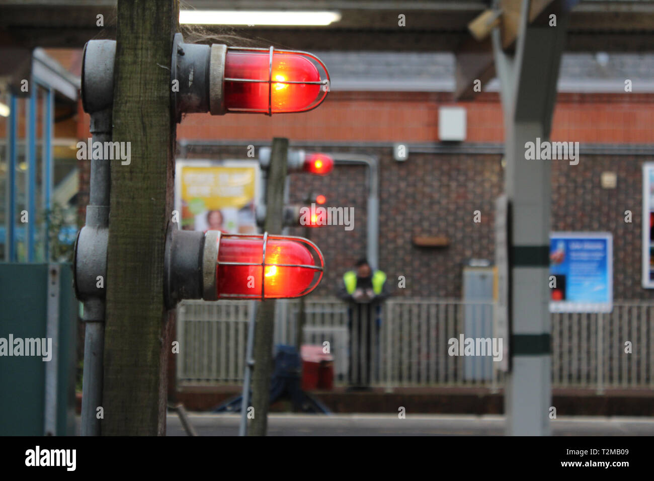 View of red light indicators with worker on the background at train ...