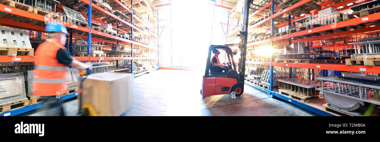 logistics and transport workers in a goods warehouse with goods for ...