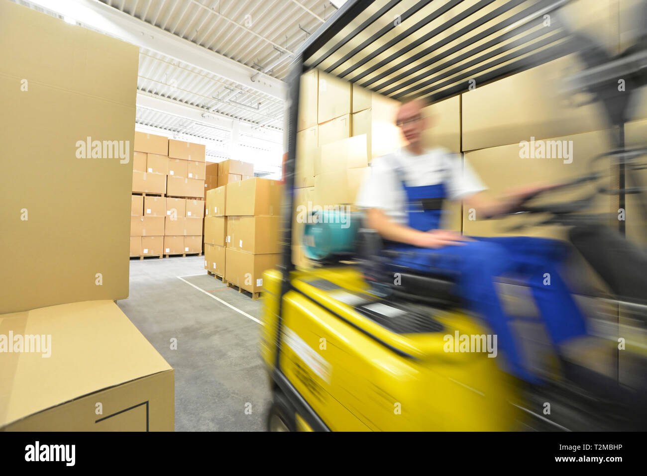 forklift driver in a warehouse for industrial goods Stock Photo - Alamy