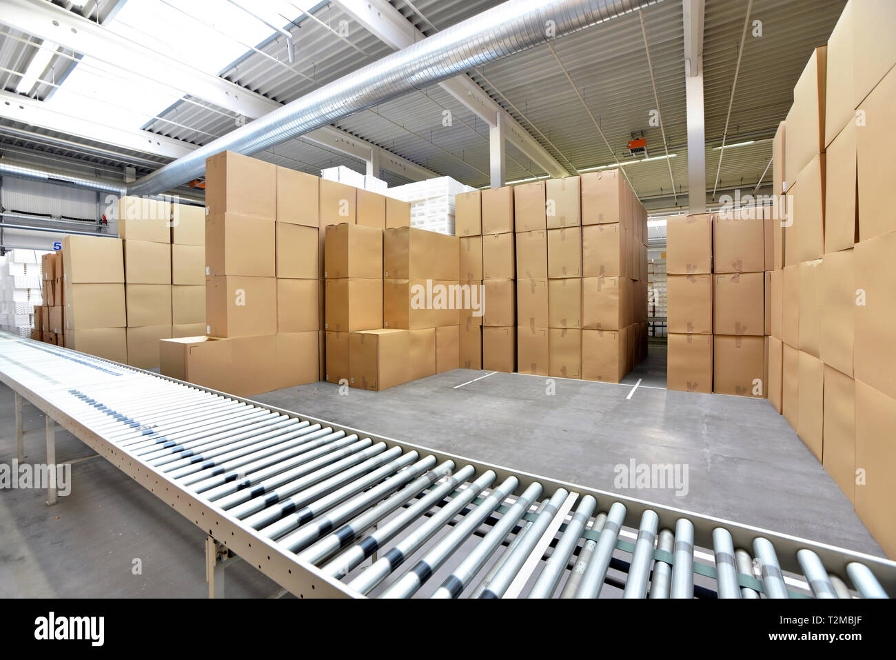 empty department store with crates for delivery and a conveyor belt ...
