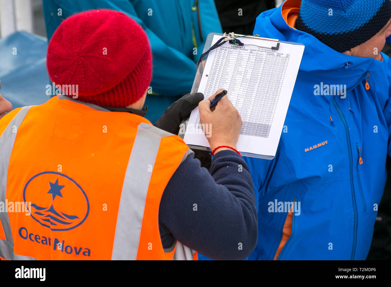 Crew and passengers go through a safety drill on an antarctic cruise ...