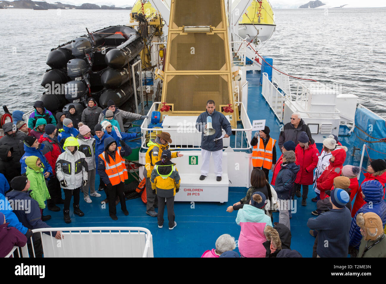 Crew and passengers go through a safety drill on an antarctic cruise ...