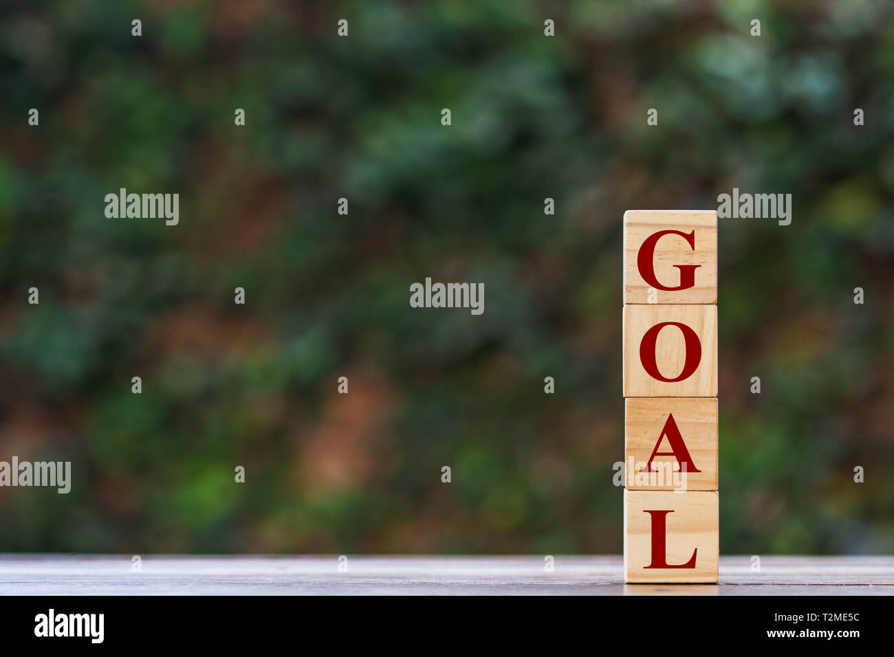 Stacked four wooden block with "GOAL" text Depicts targeting and ...