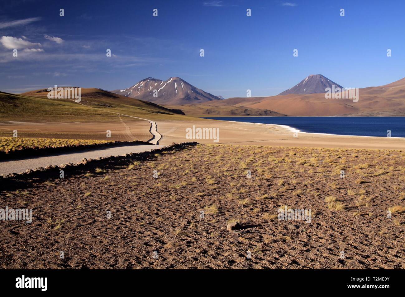 View on track along deep blue lake at Altiplanic Laguna (Lagoon ...
